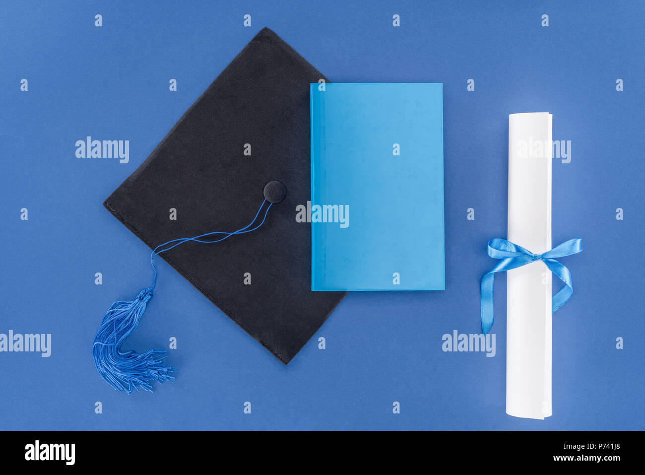High school concept with diploma and graduation cap isolated on blue ...
