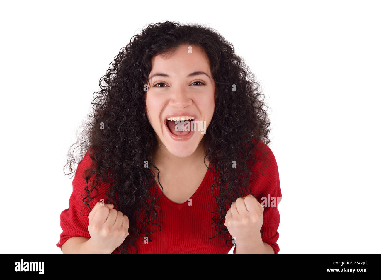 Portrait of young latin woman celebrating success. Isolated white ...