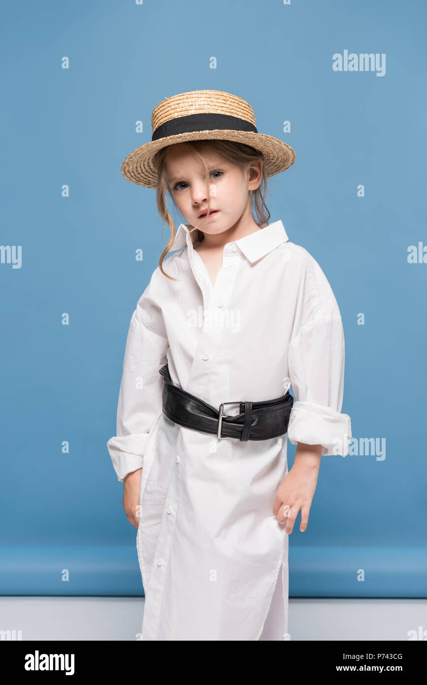 adorable little girl posing in white shirt and straw boater, studio ...