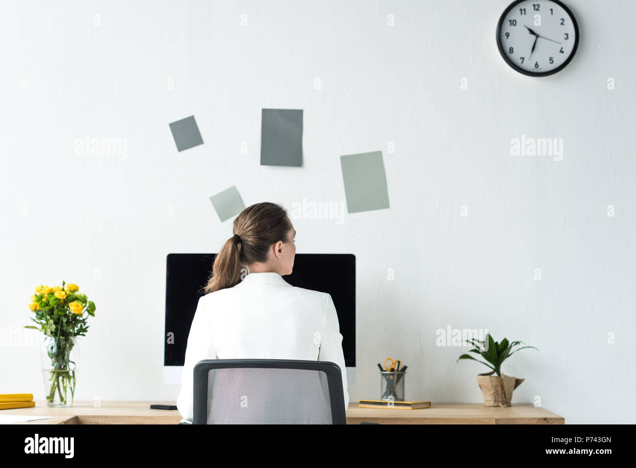 back view of businesswoman at workplace with computer screen in office ...