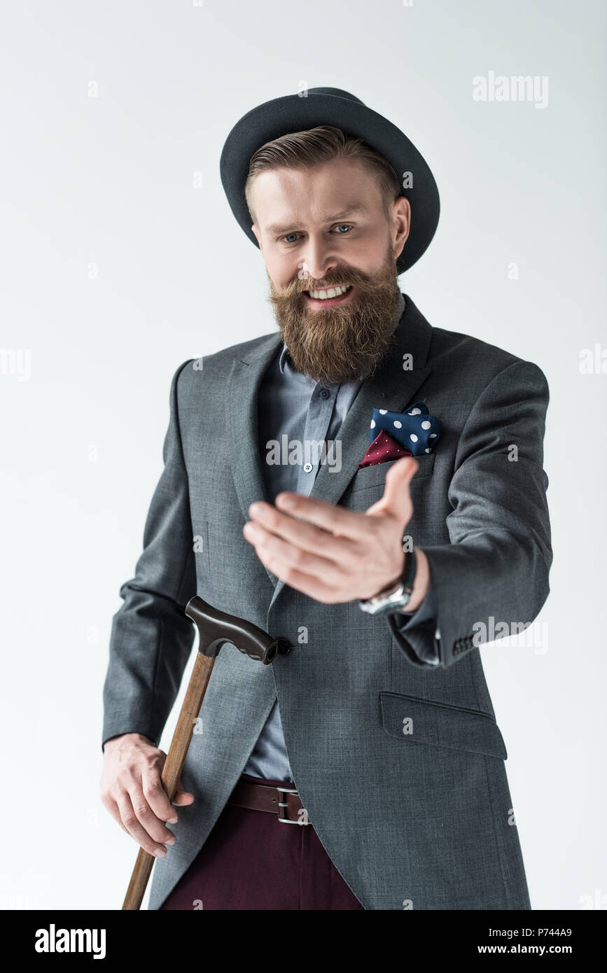 Handsome man in vintage style clothes holding cane and reaching with ...