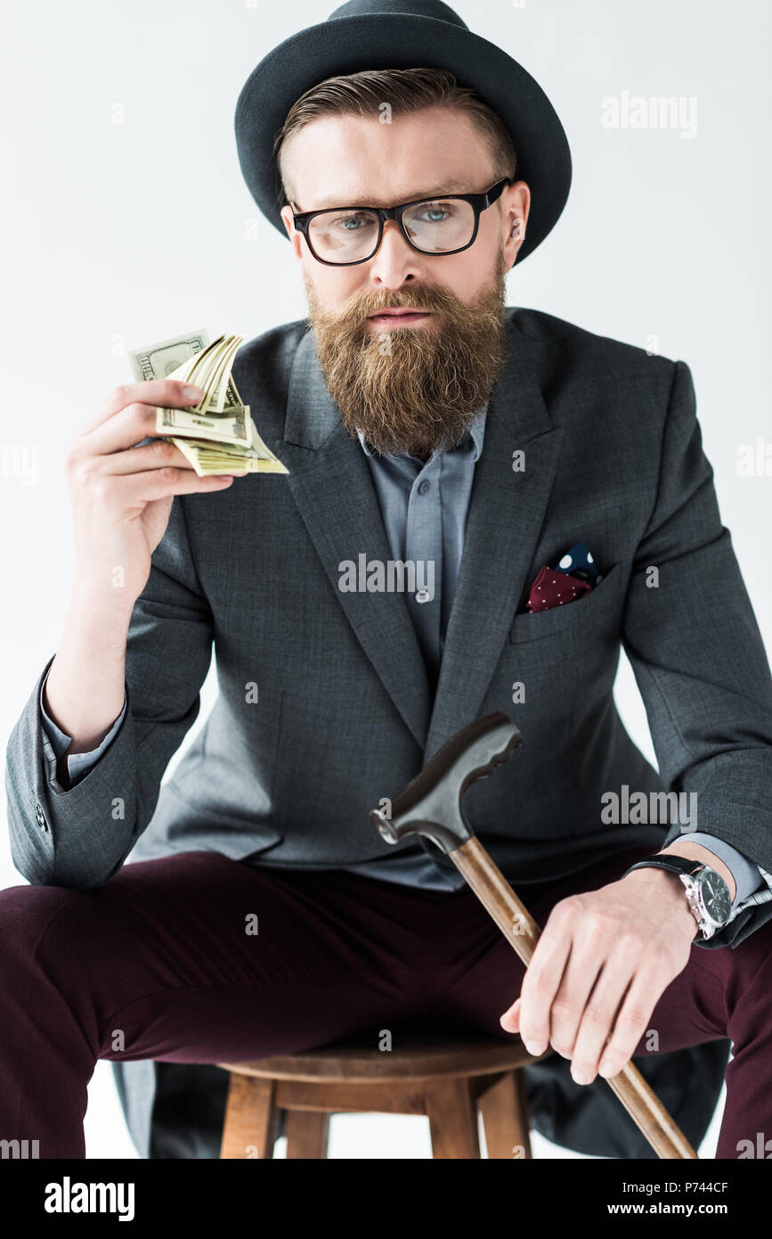 Businessman with vintage mustache and beard holding dollars isolated on ...