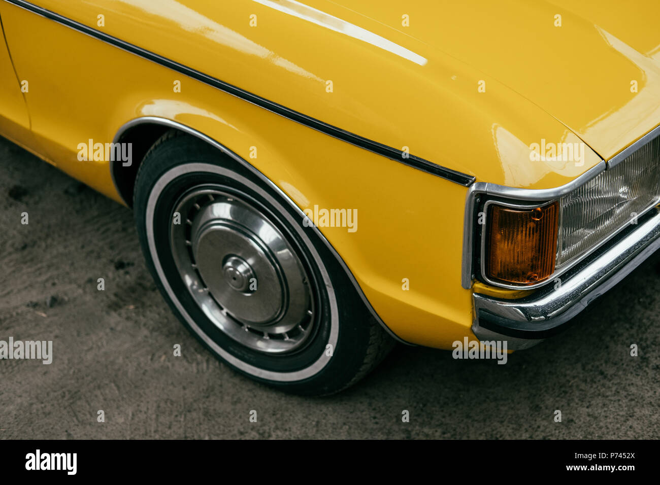 close-up view of wheel of yellow old-fashioned automobile Stock Photo ...