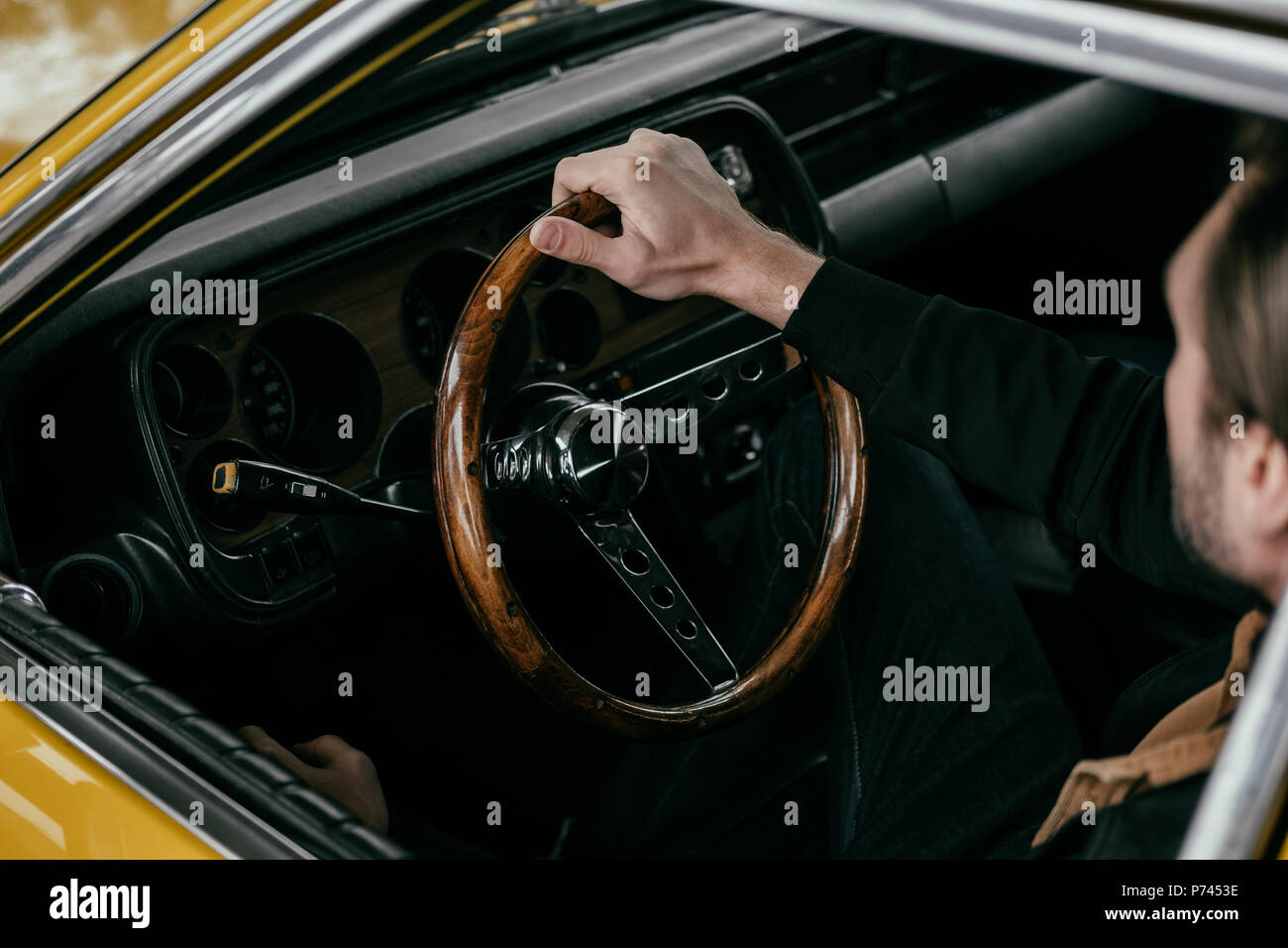 high angle view of man holding steering wheel of old-fashioned ...