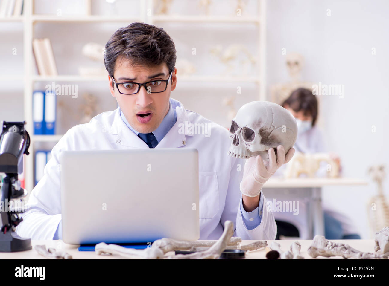 Professor studying human skeleton in lab Stock Photo - Alamy