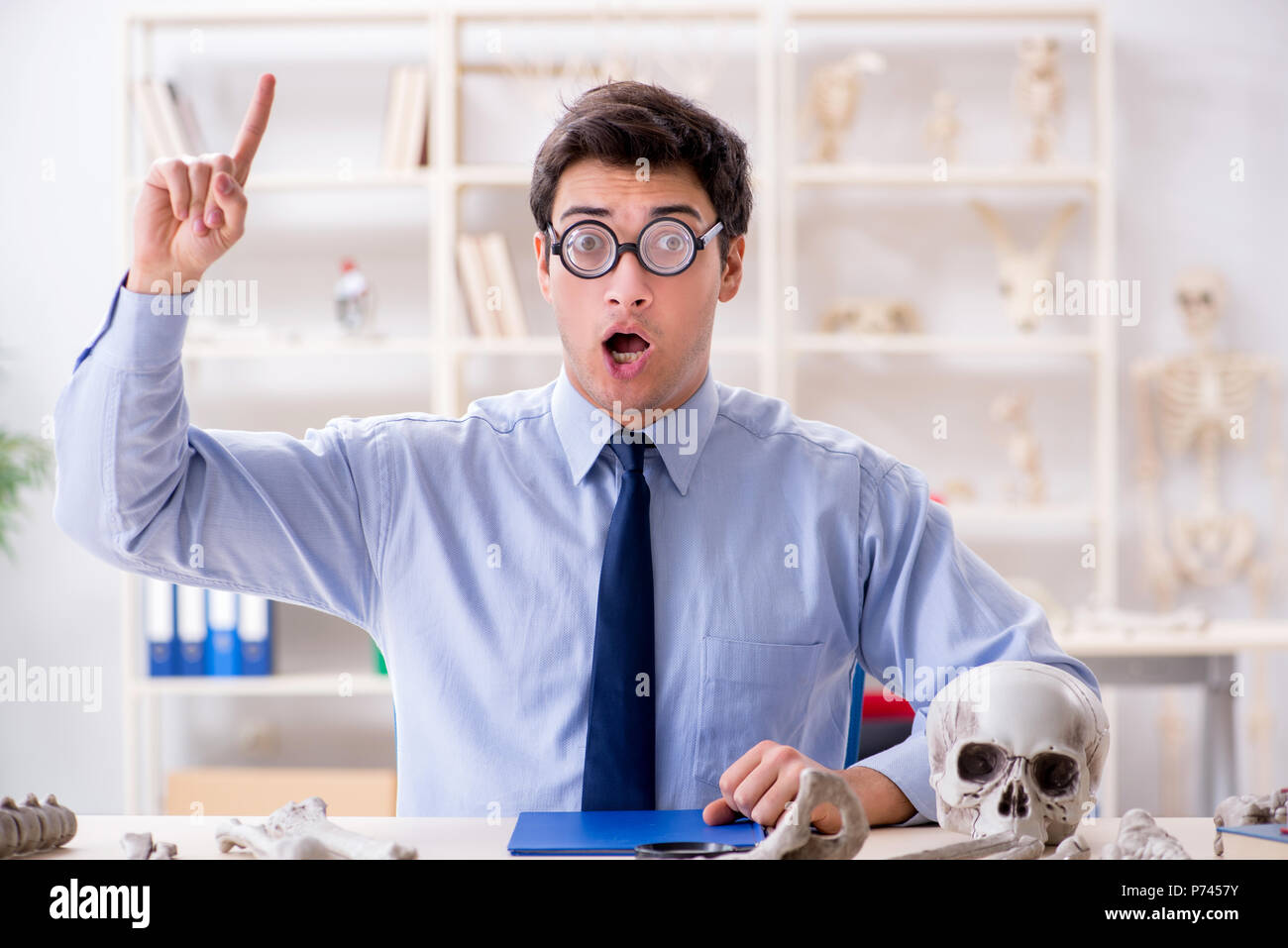 Funny crazy professor studying human skeleton Stock Photo - Alamy