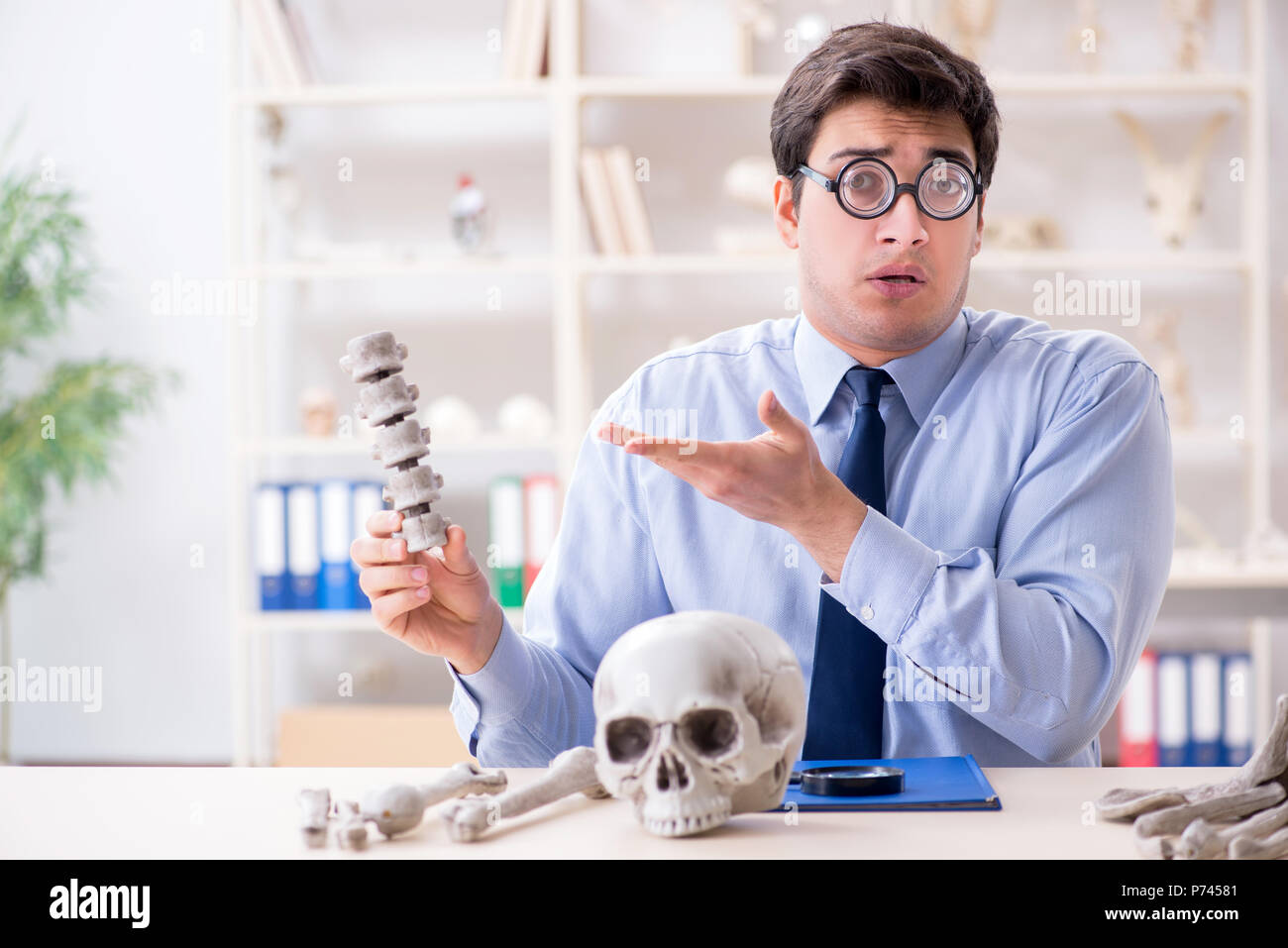 Funny crazy professor studying human skeleton Stock Photo - Alamy