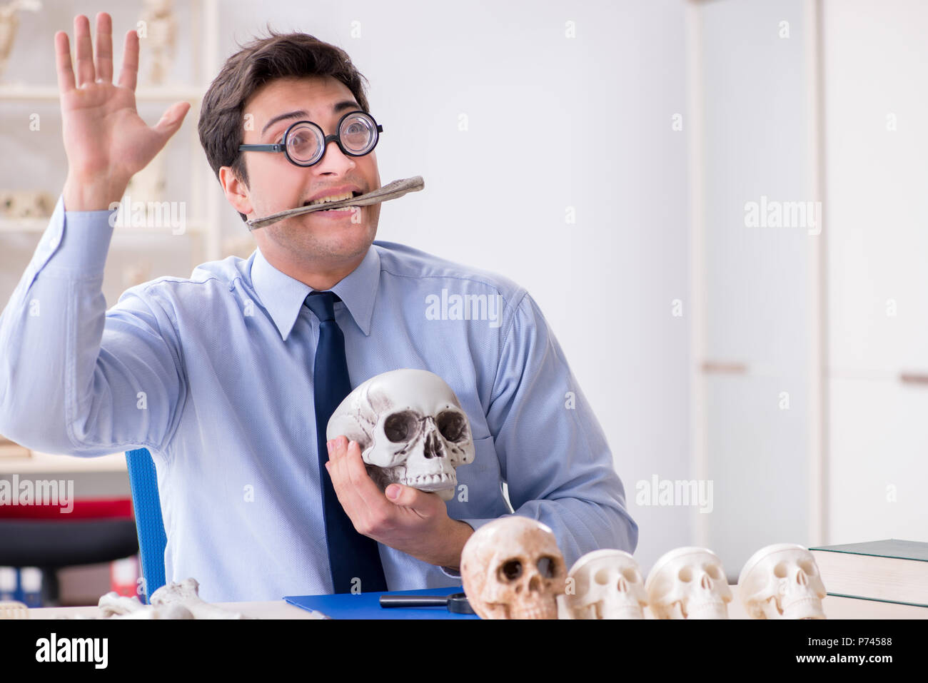 Funny crazy professor studying human skeleton Stock Photo - Alamy