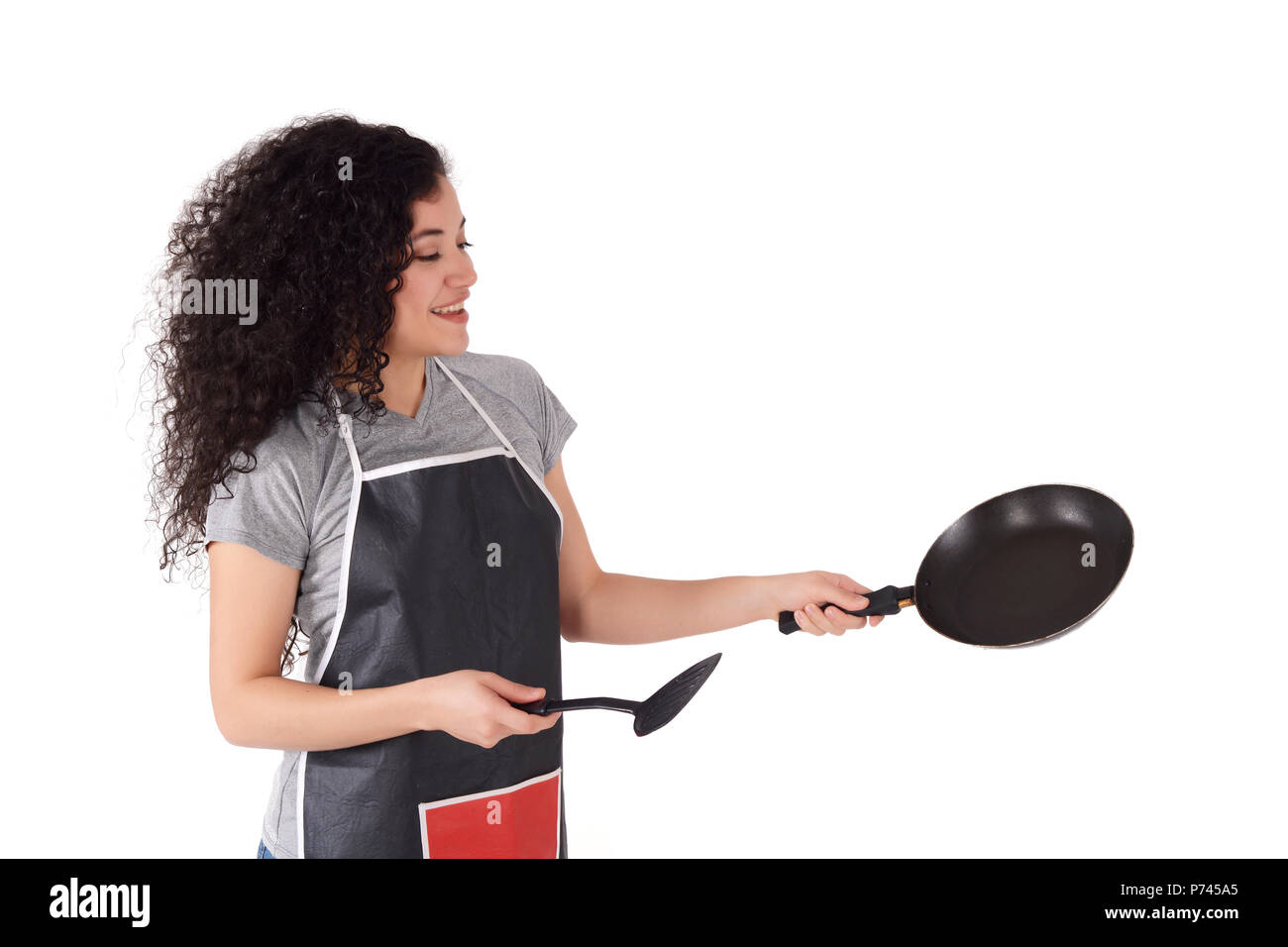 Portrait of Young beautiful woman cooking. Isolated white background ...