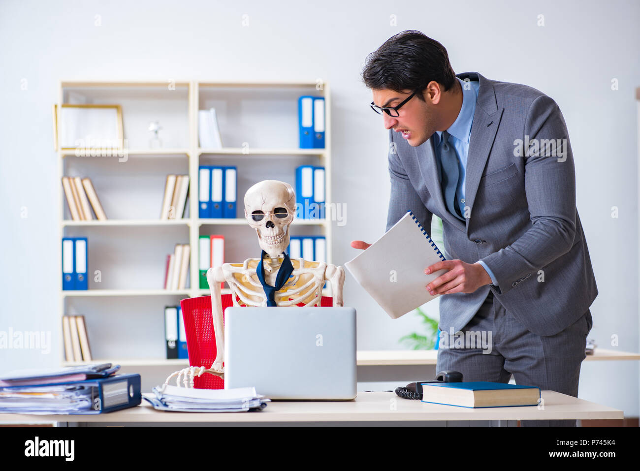 Angry boss yelling at his skeleton employee Stock Photo - Alamy