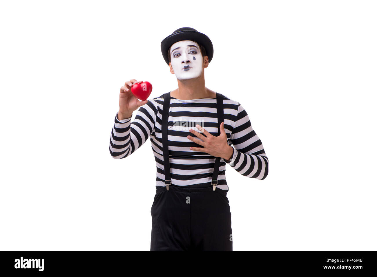 Mime holding red heart isolated on white background Stock Photo - Alamy