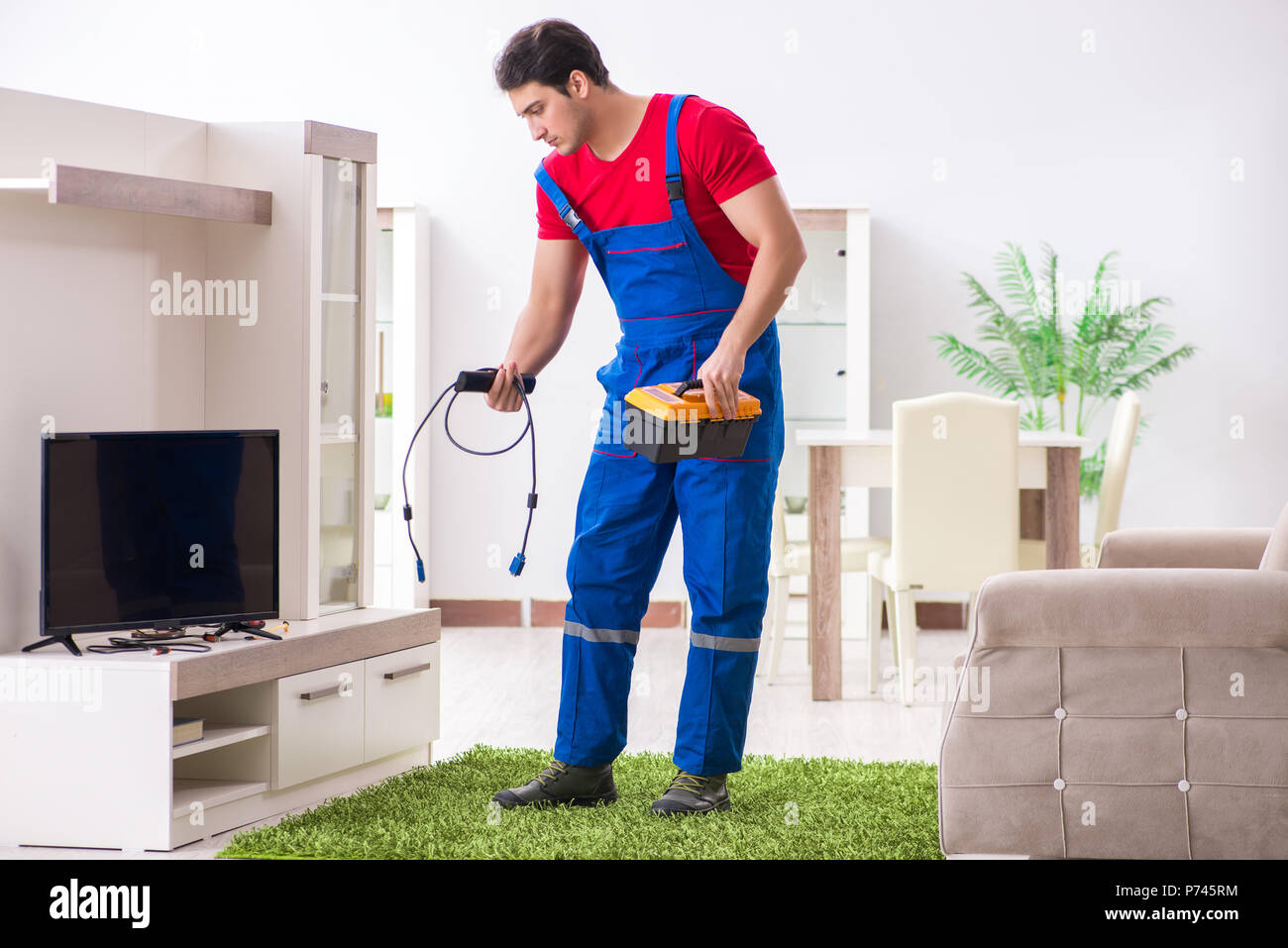 Professional repair engineer repairing broken tv Stock Photo - Alamy