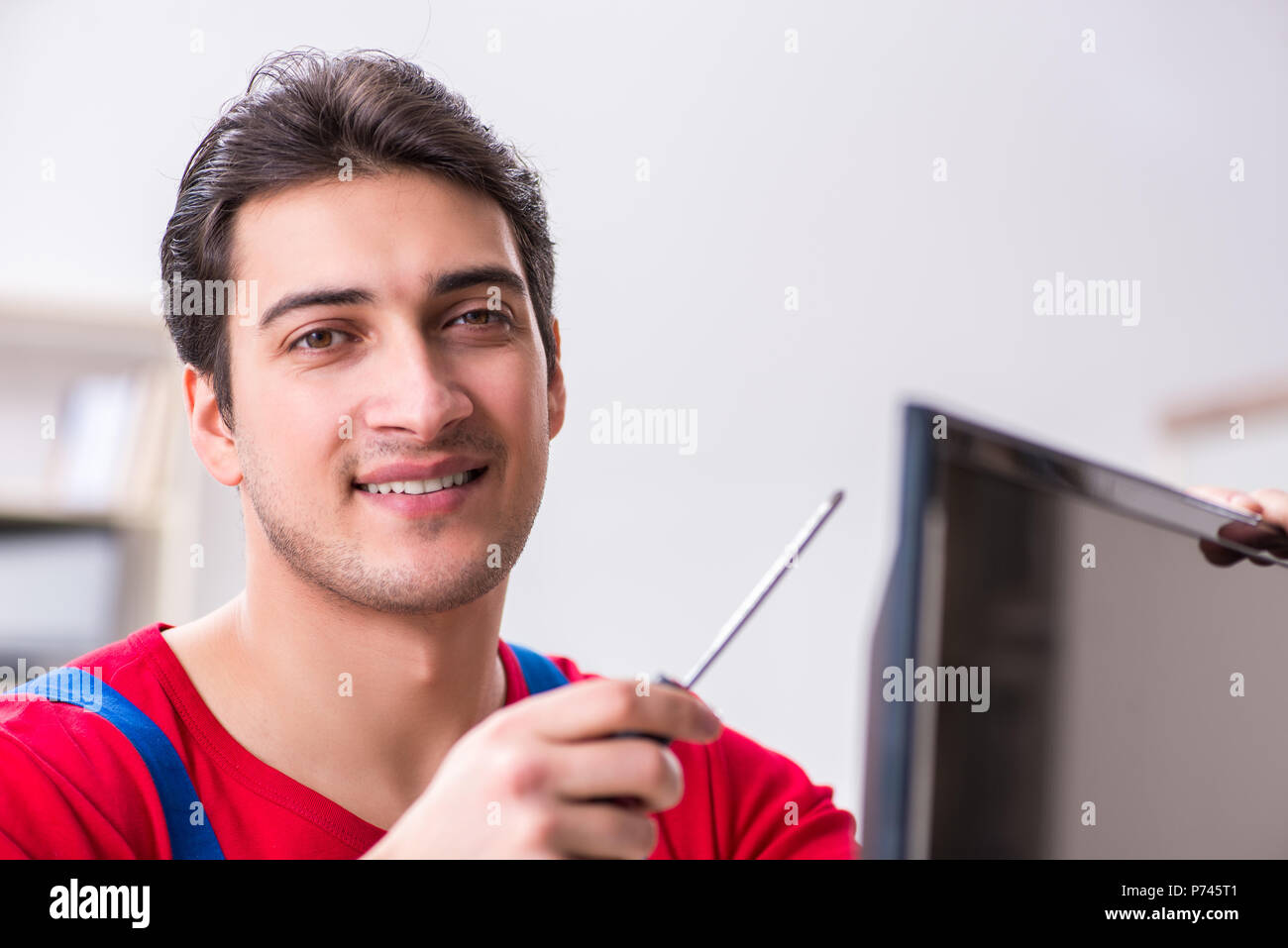 Professional repair engineer repairing broken tv Stock Photo - Alamy