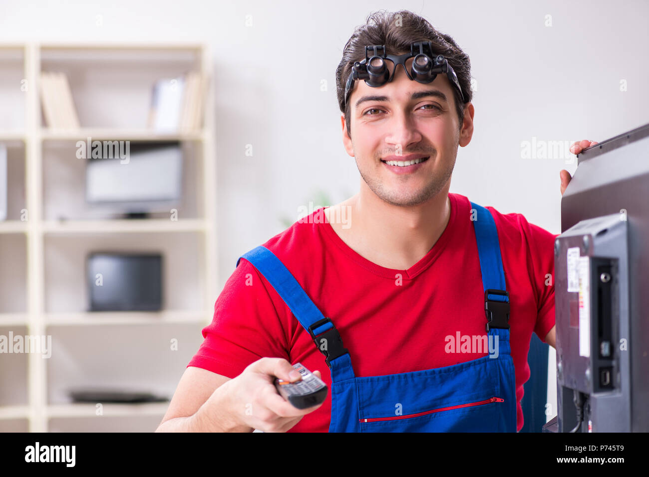 Professional repair engineer repairing broken tv Stock Photo - Alamy