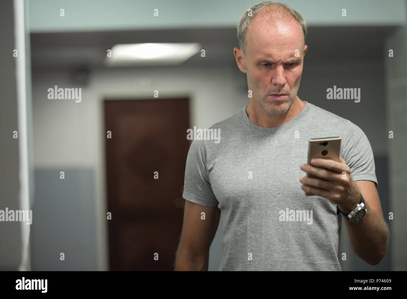 Mature Scandinavian man using phone at hotel Stock Photo - Alamy