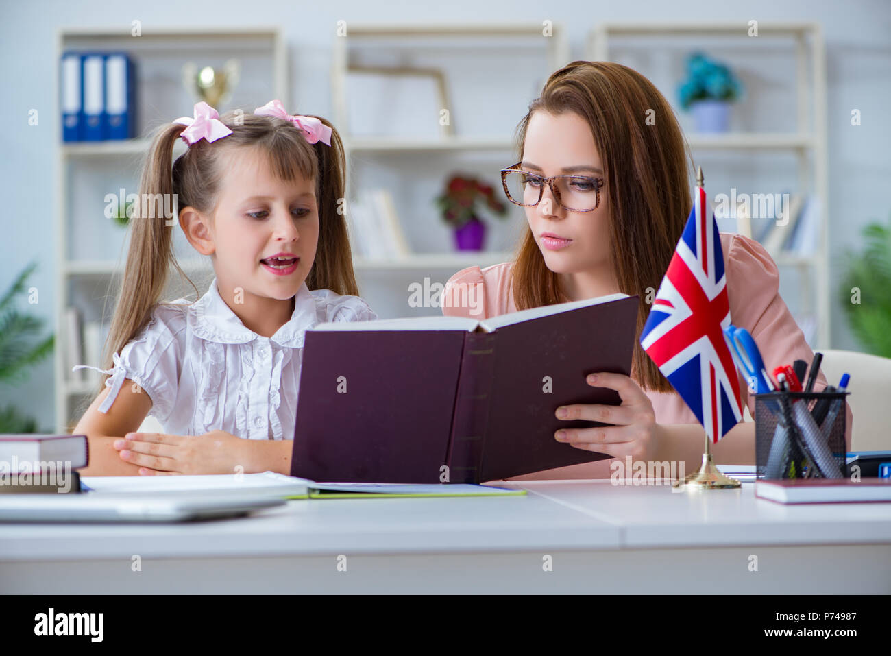 Young girl learning english with teacher Stock Photo - Alamy