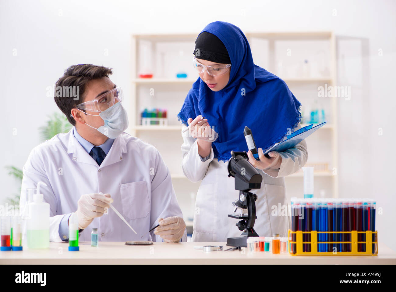 Two chemists working in the lab Stock Photo - Alamy