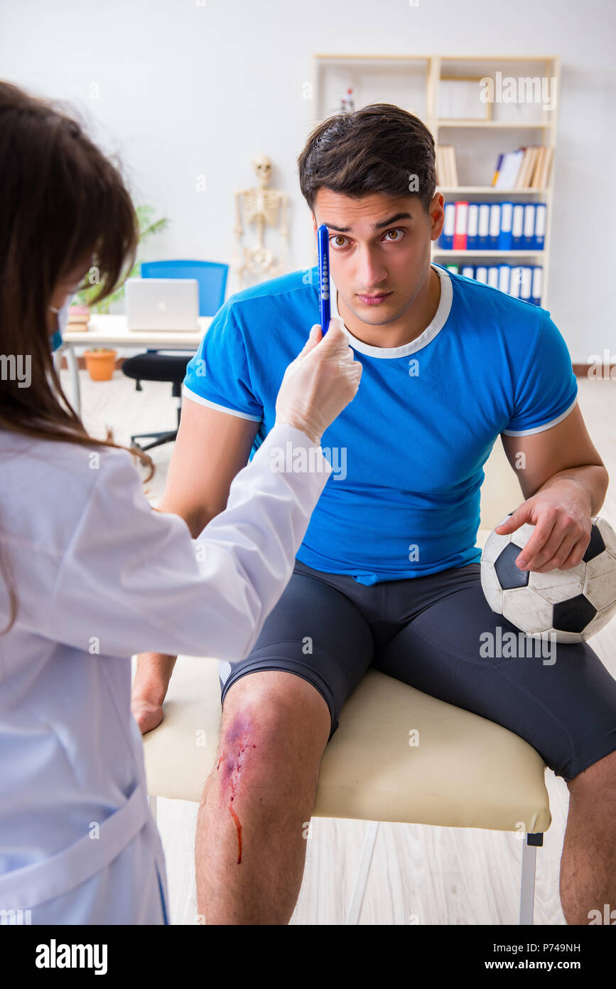 Football soccer player visiting doctor after injury Stock Photo - Alamy