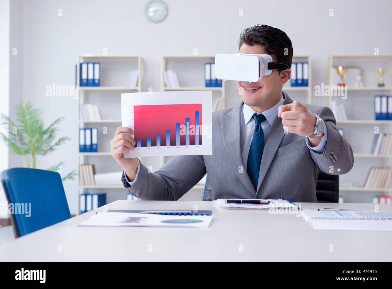 Businessman with virtual reality glasses in the office Stock Photo - Alamy