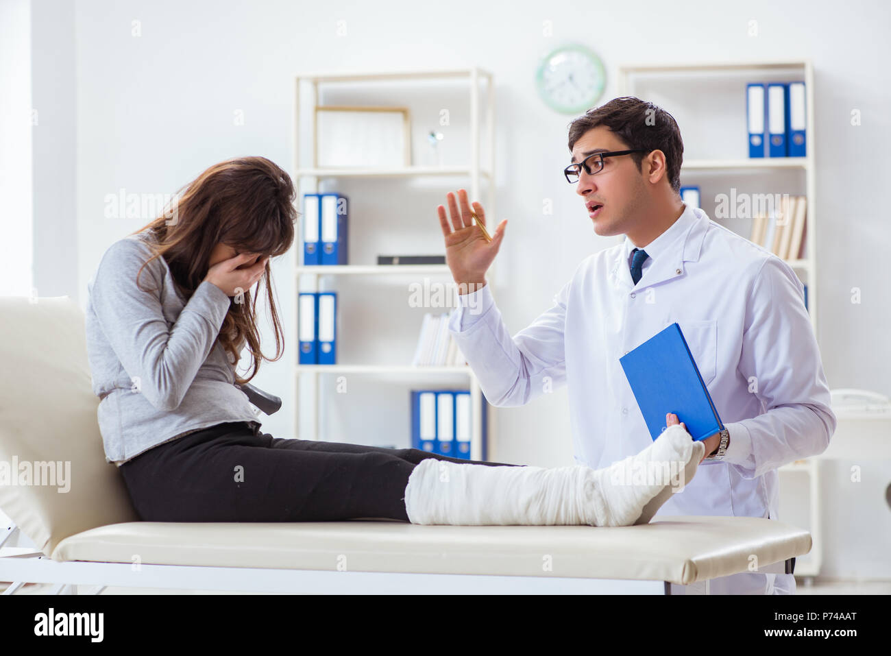 Doctor examining patient with broken leg Stock Photo - Alamy