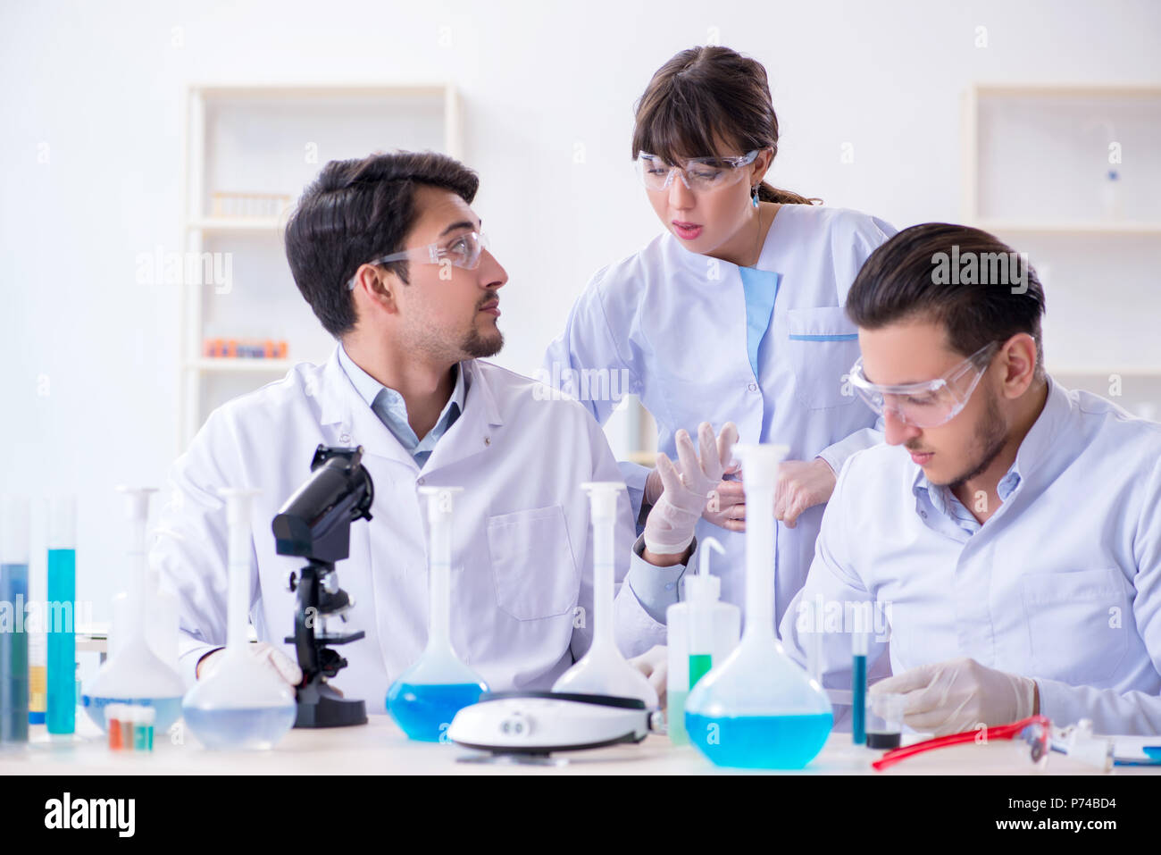 Team of chemists working in the lab Stock Photo - Alamy