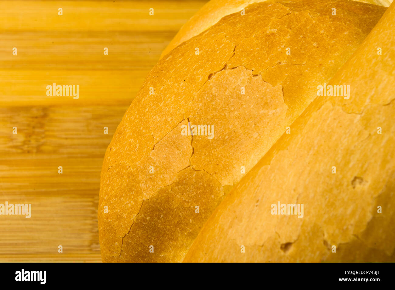 fresh braided loaf of white wheat bread on bamboo wooden background ...