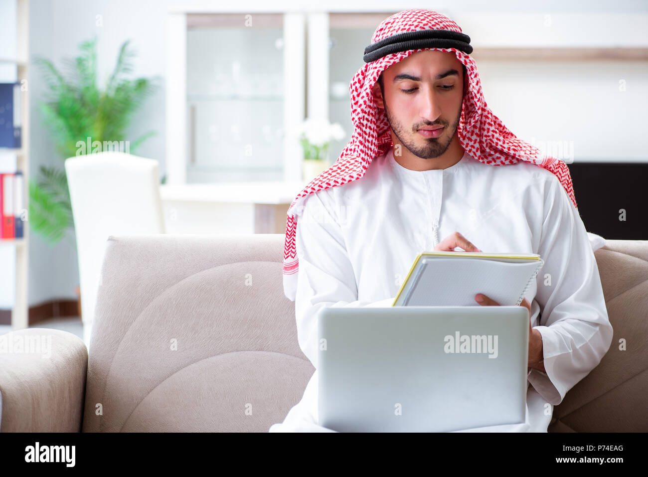 Arab man working at home on his work Stock Photo - Alamy
