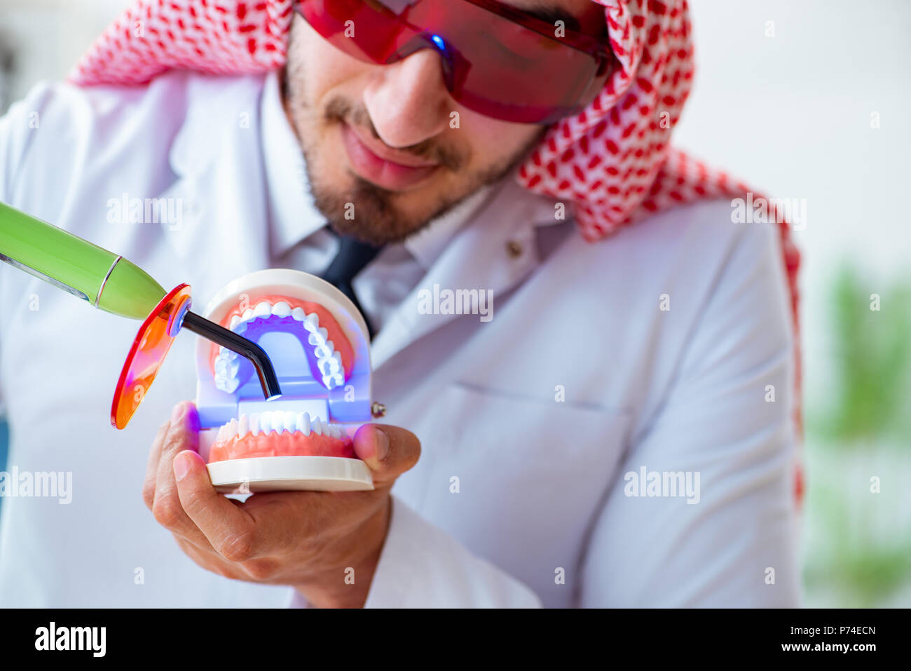 Arab dentist working on new teeth implant Stock Photo - Alamy