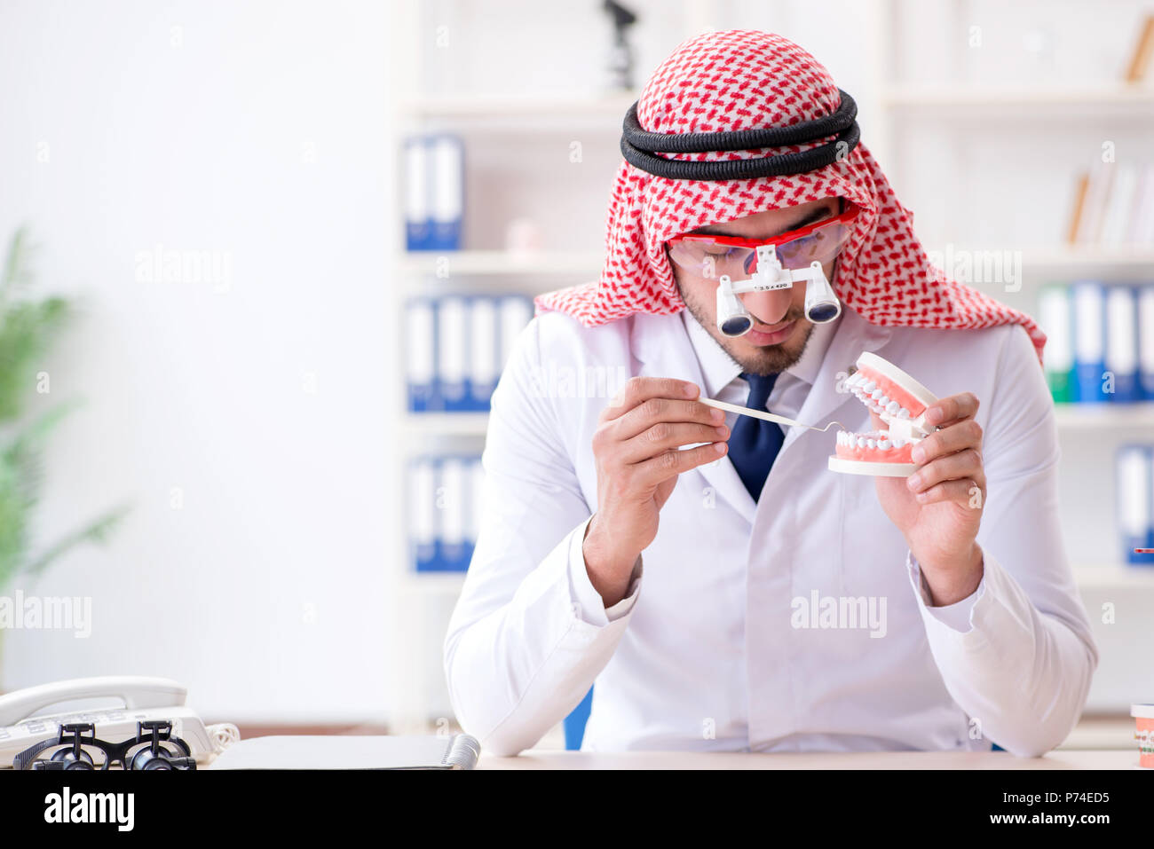 Arab dentist working on new teeth implant Stock Photo - Alamy
