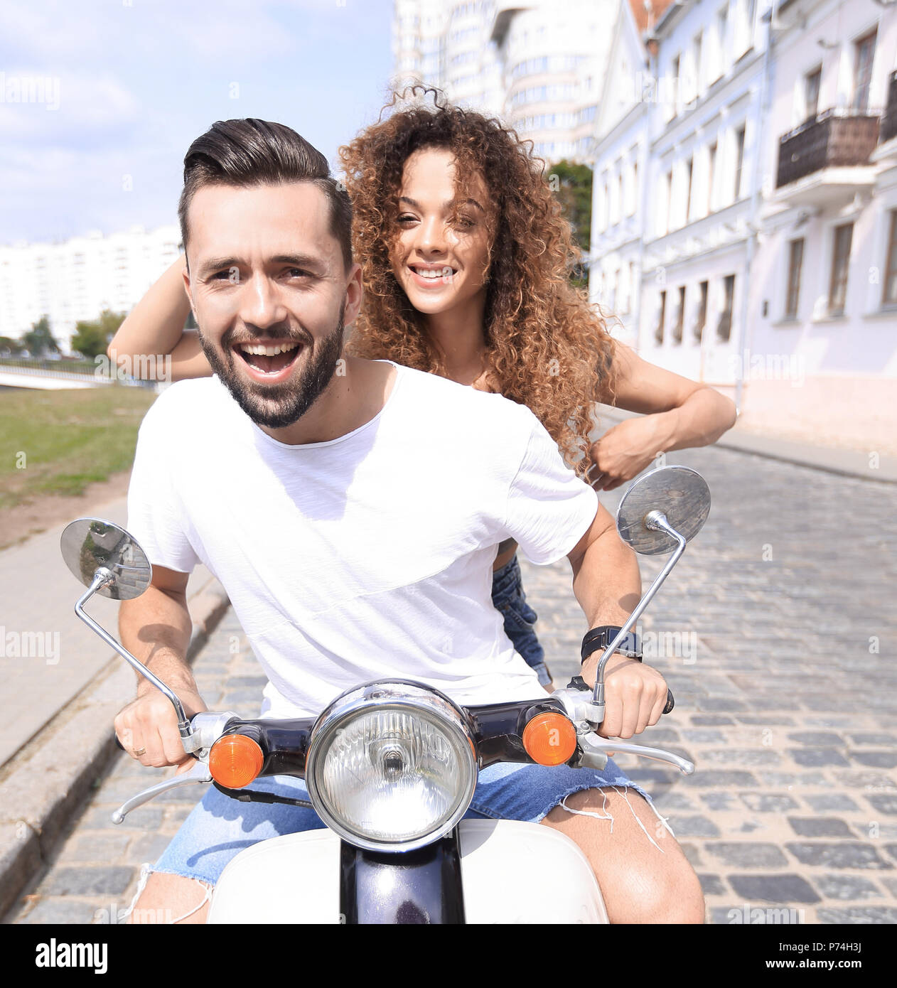 Happy cheerful couple riding vintage scooter outdoors Stock Photo - Alamy