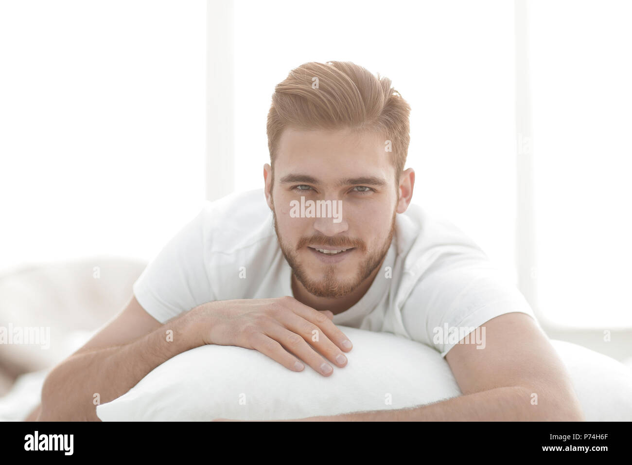 closeup.smiling man lying on the sofa Stock Photo - Alamy