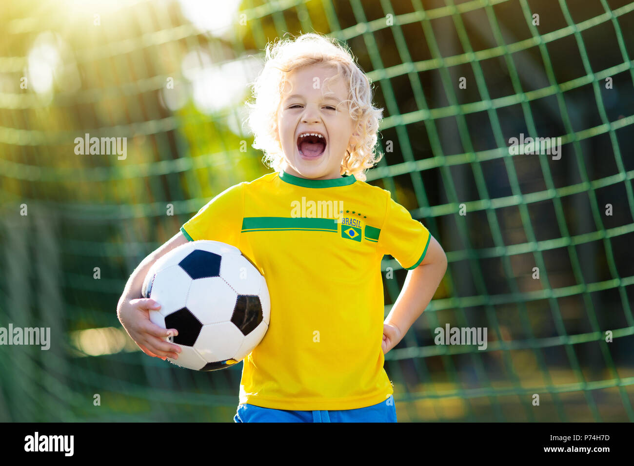 Brazilian children playing football on hi-res stock photography and ...