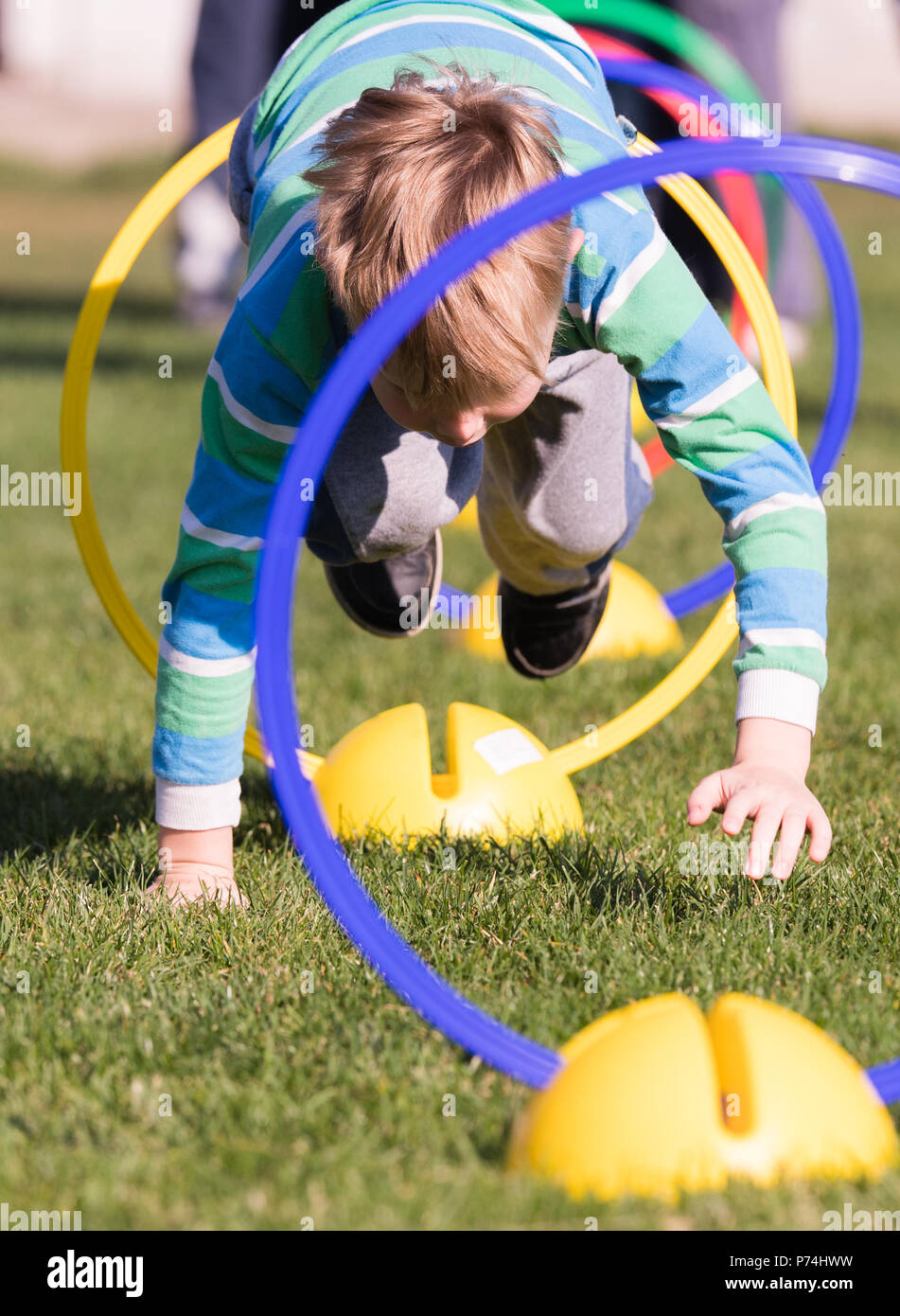 Child playing in a exercising circle - tunnel tube, crawling through it ...