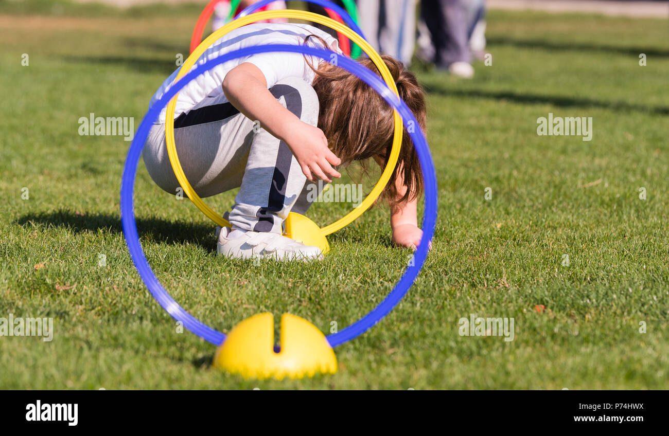 Child playing in a exercising circle - tunnel tube, crawling through it ...