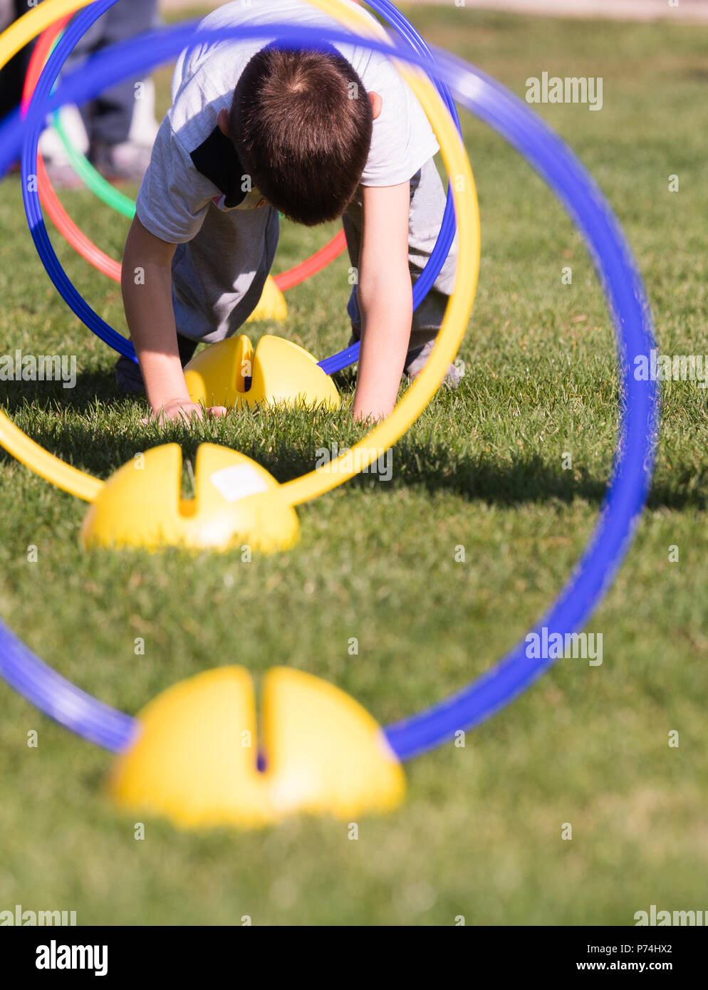 Child playing in a exercising circle - tunnel tube, crawling through it ...