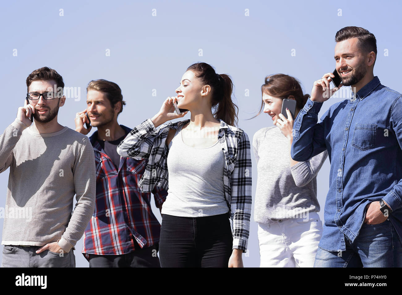 group of students talking on their smartphones Stock Photo - Alamy