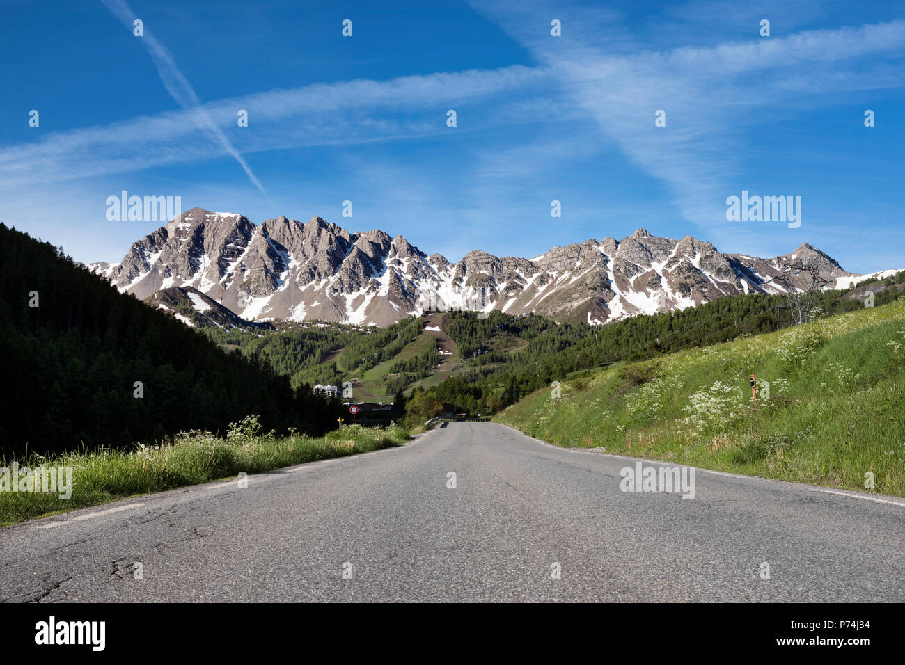 road and snow capped mountains in parc mercantour in the french ...