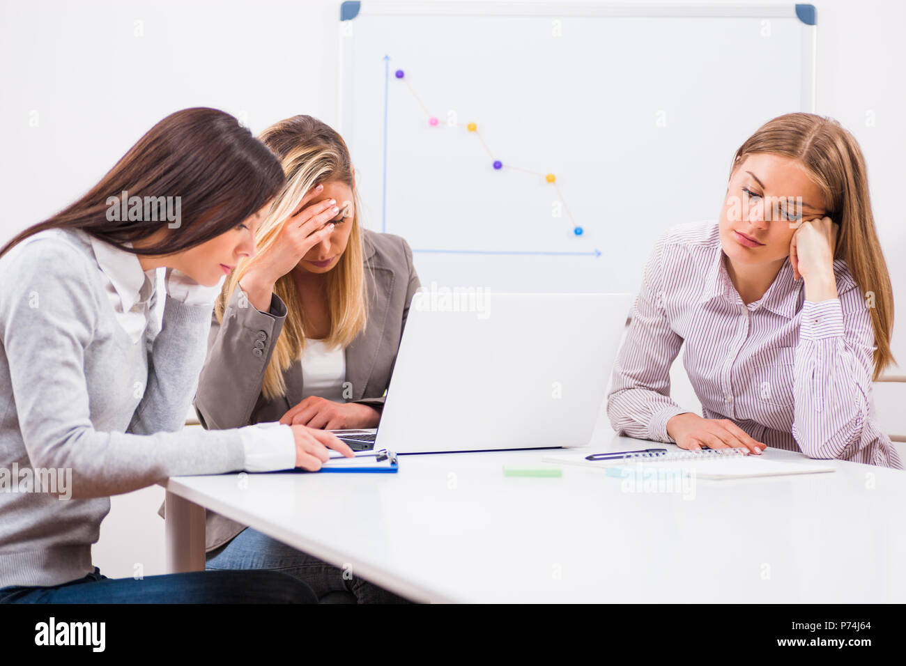 Three businesswomen are tired from working overtime Stock Photo - Alamy