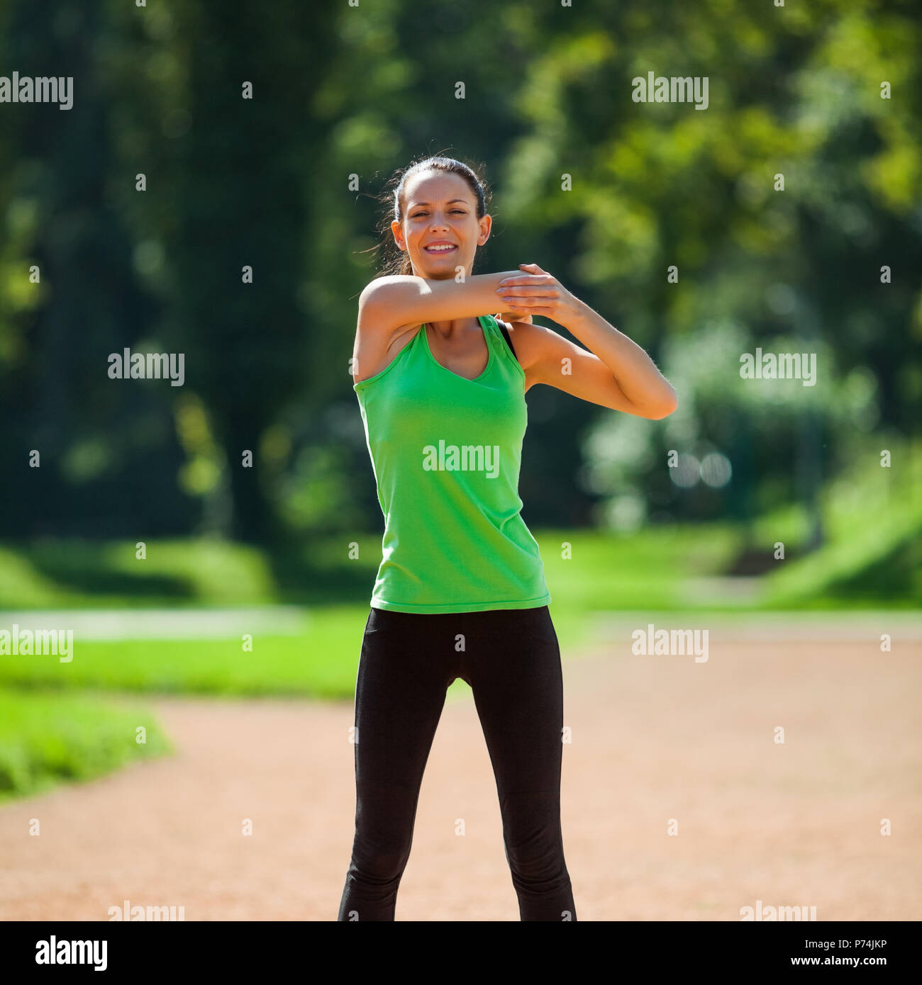 Young woman stretching her body, warming up for jogging Stock Photo - Alamy