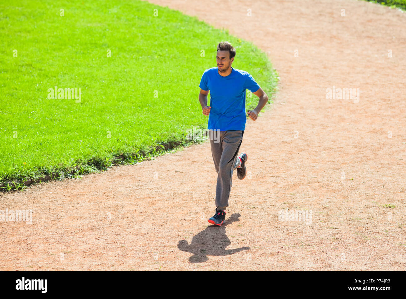 Young man jogging Stock Photo - Alamy