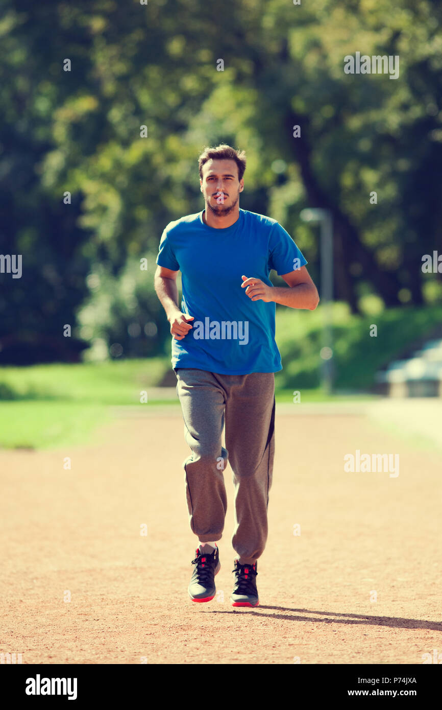 Young man jogging Stock Photo - Alamy