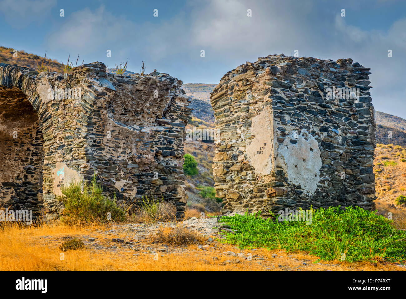 An ancient wall with an arch of stone built in the mountains Stock ...