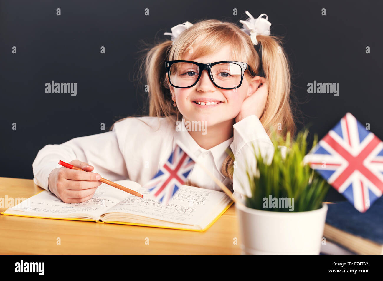 Happy cute smiling girl wears in smart eyeglasses learning English ...