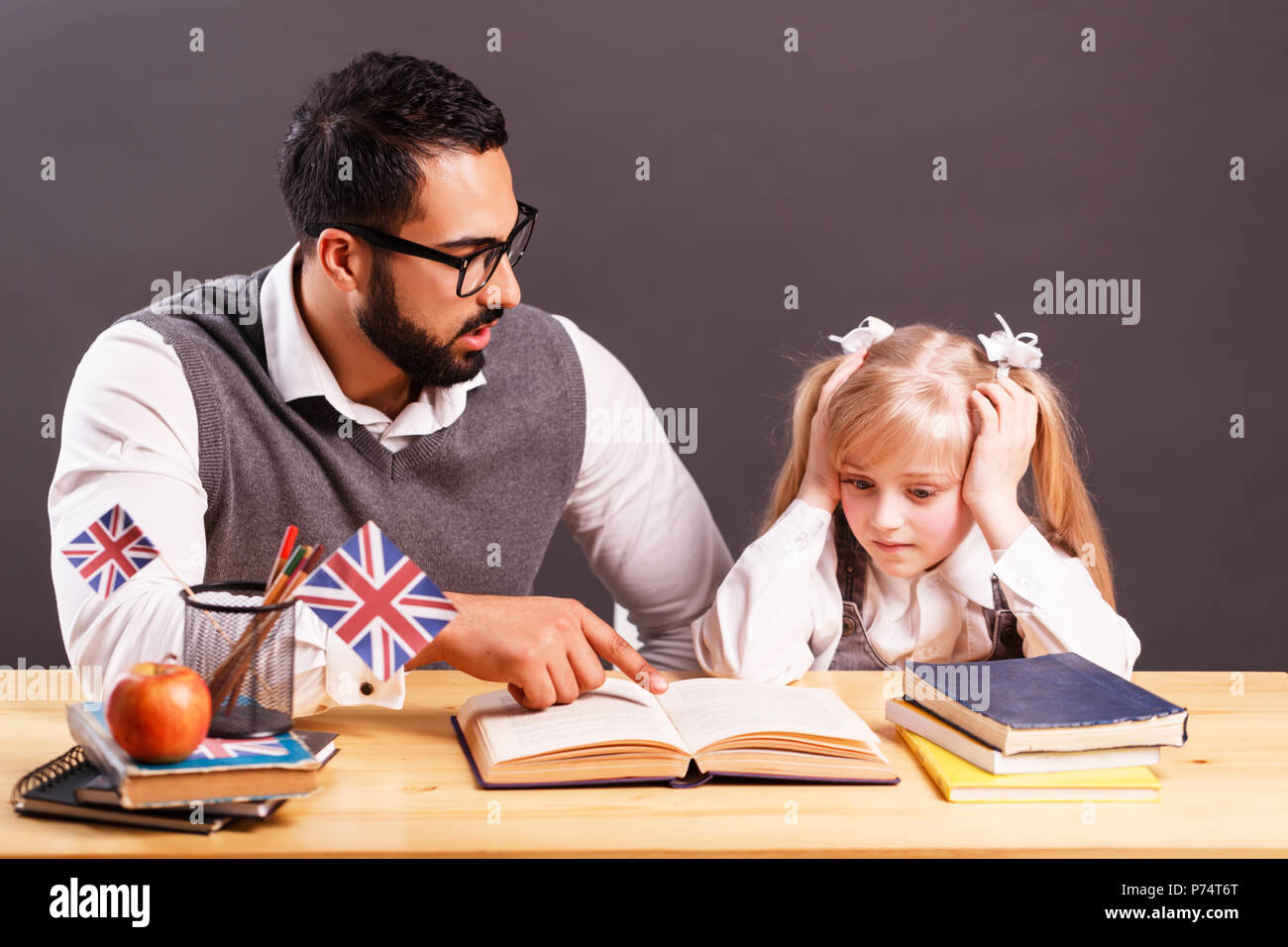 Teacher explaining new material to the primary tired student girl at ...
