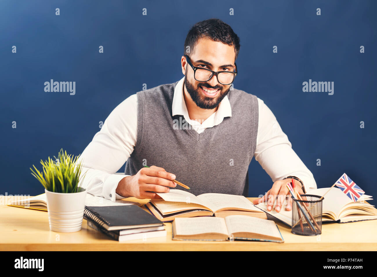Eastern bearded man working hard learning english, wearing gray sweater ...