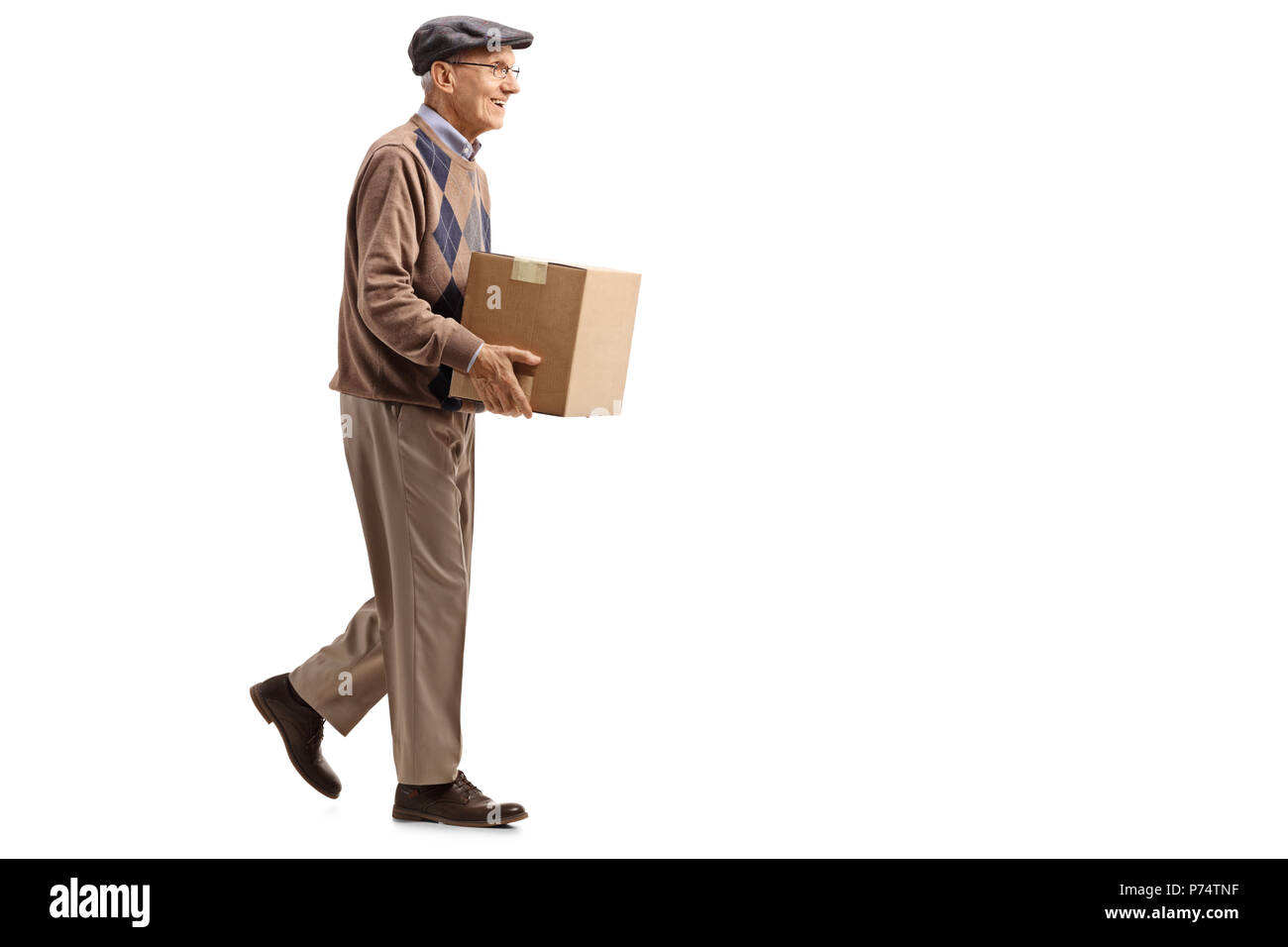 Full length profile shot of a senior walking and carrying a package ...