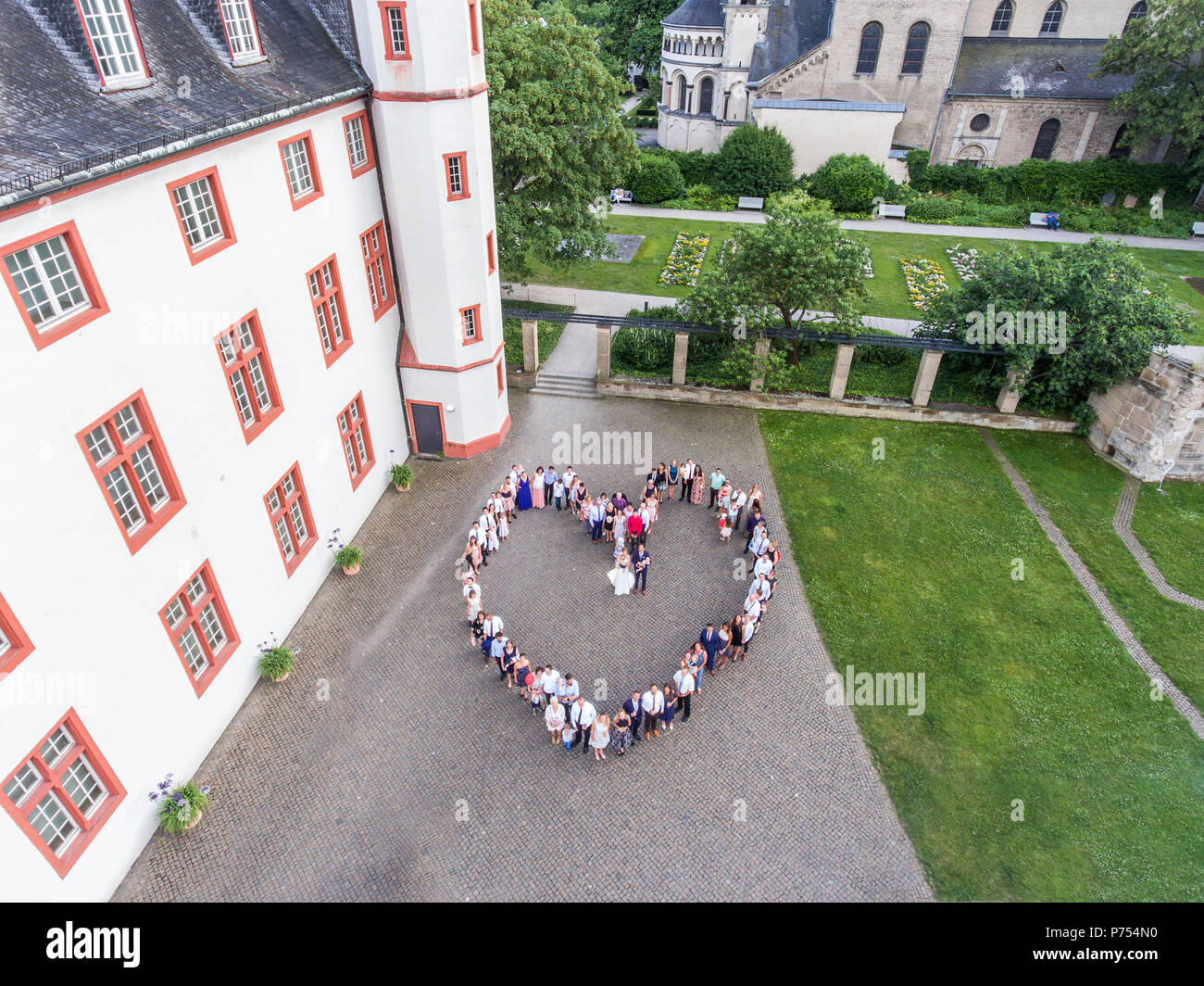 Wedding guests lined up in the shape of heart with bride and groom ...