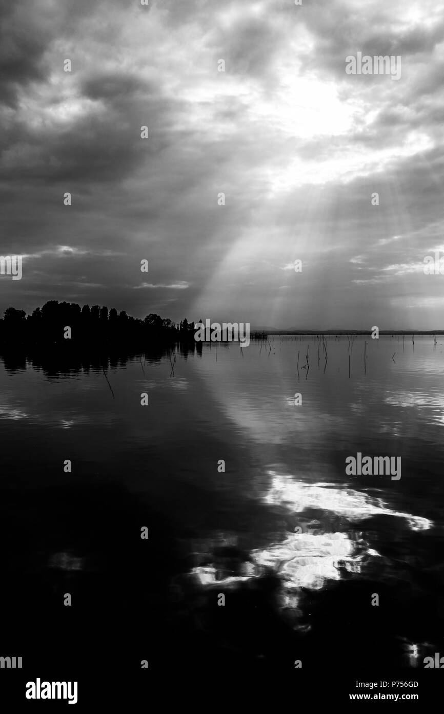 Perfectly symmetric and spectacular view of a lake, with clouds, sky ...
