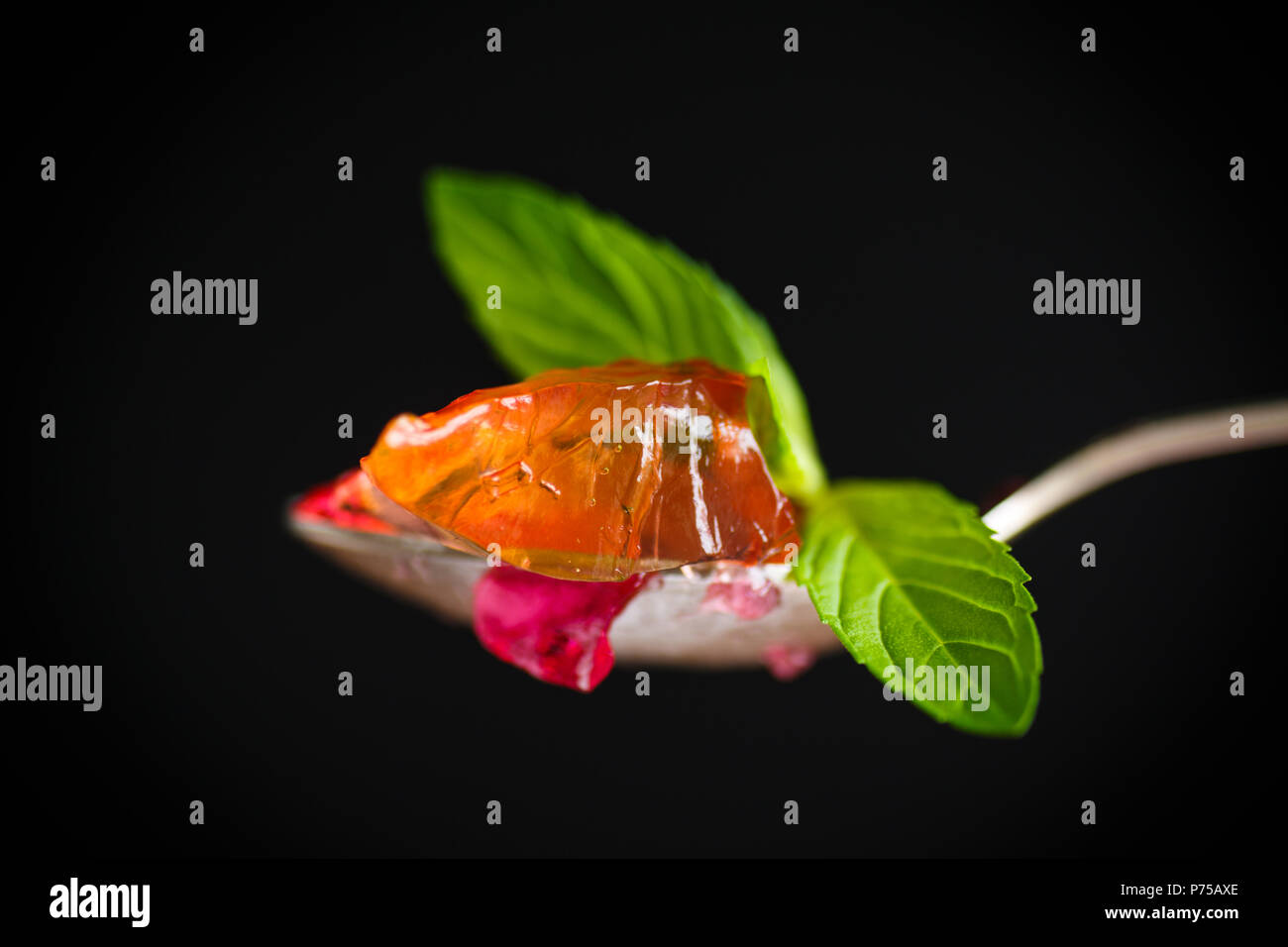 sweet multi-colored jelly on a black background Stock Photo - Alamy