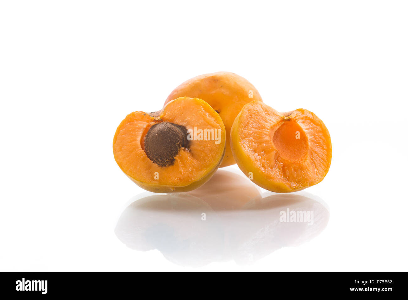 ripe two apricots isolated on white background Stock Photo - Alamy
